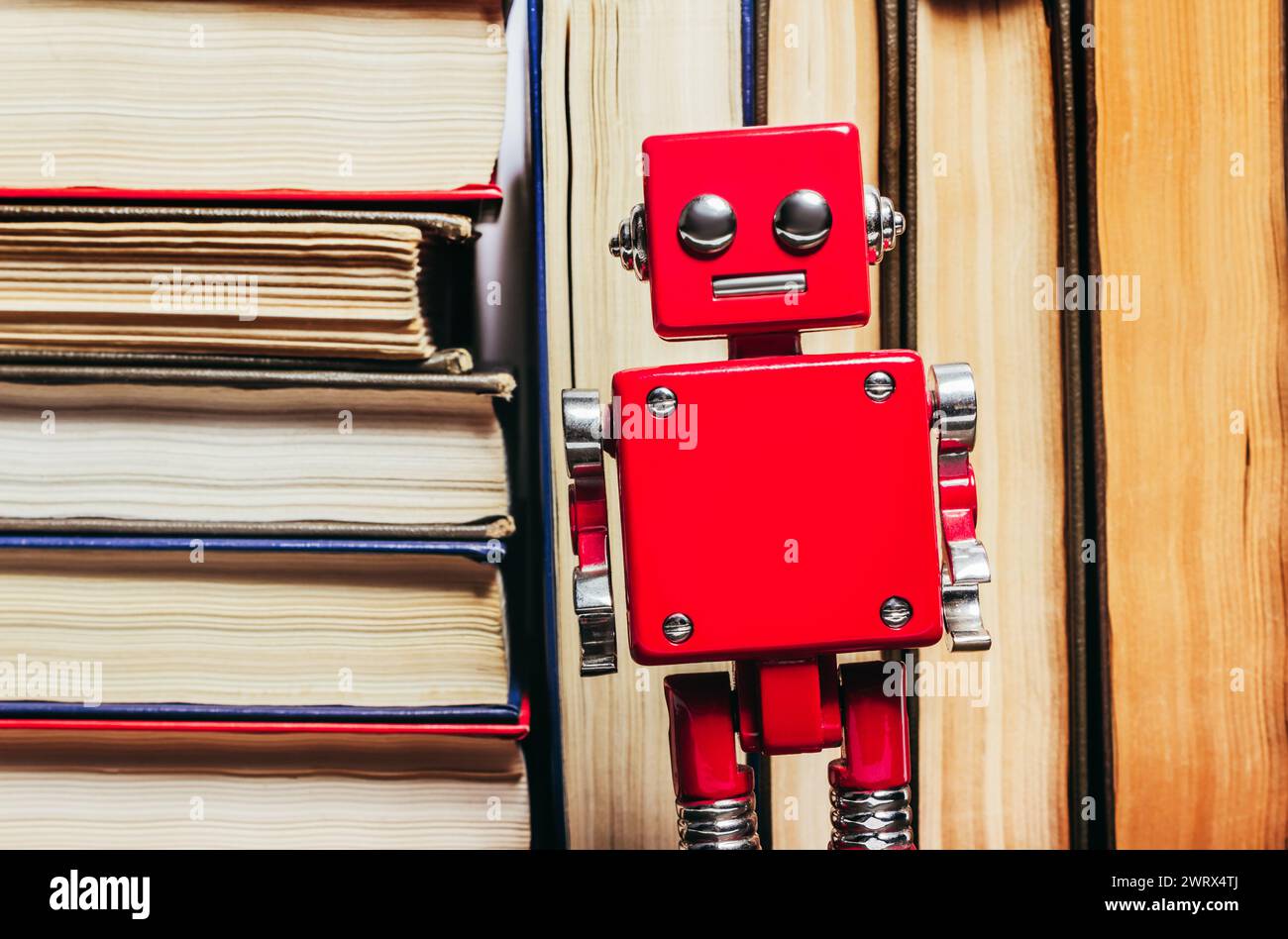 Photo of old antique books stack and row with robot toy, close up view ...
