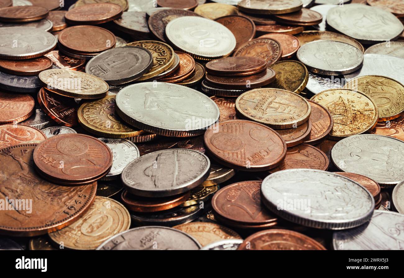Photo of various european and american coins pile, side view Stock ...