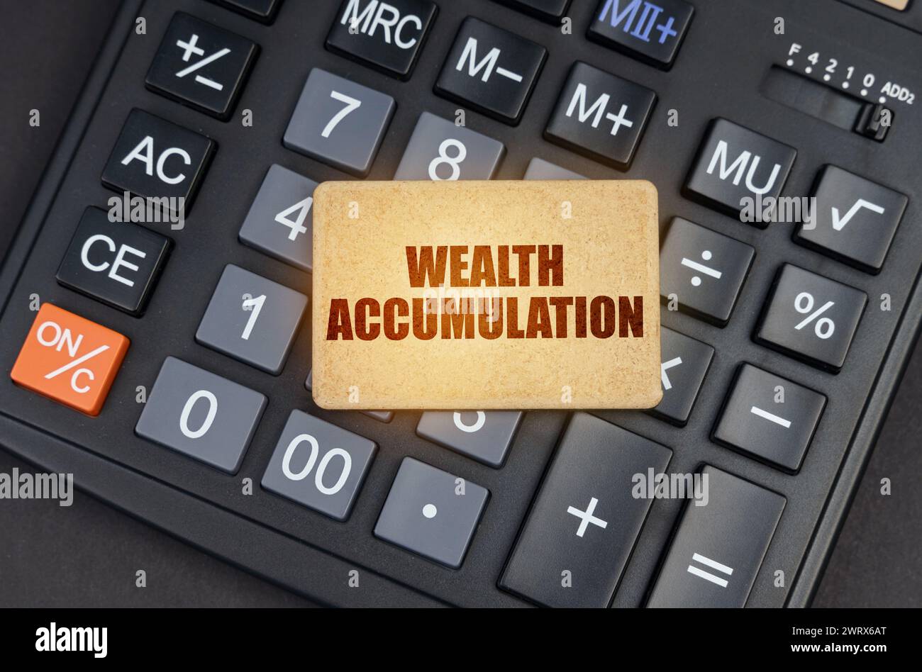 Financial concept. There is a sign on the calculator that says - Wealth ...