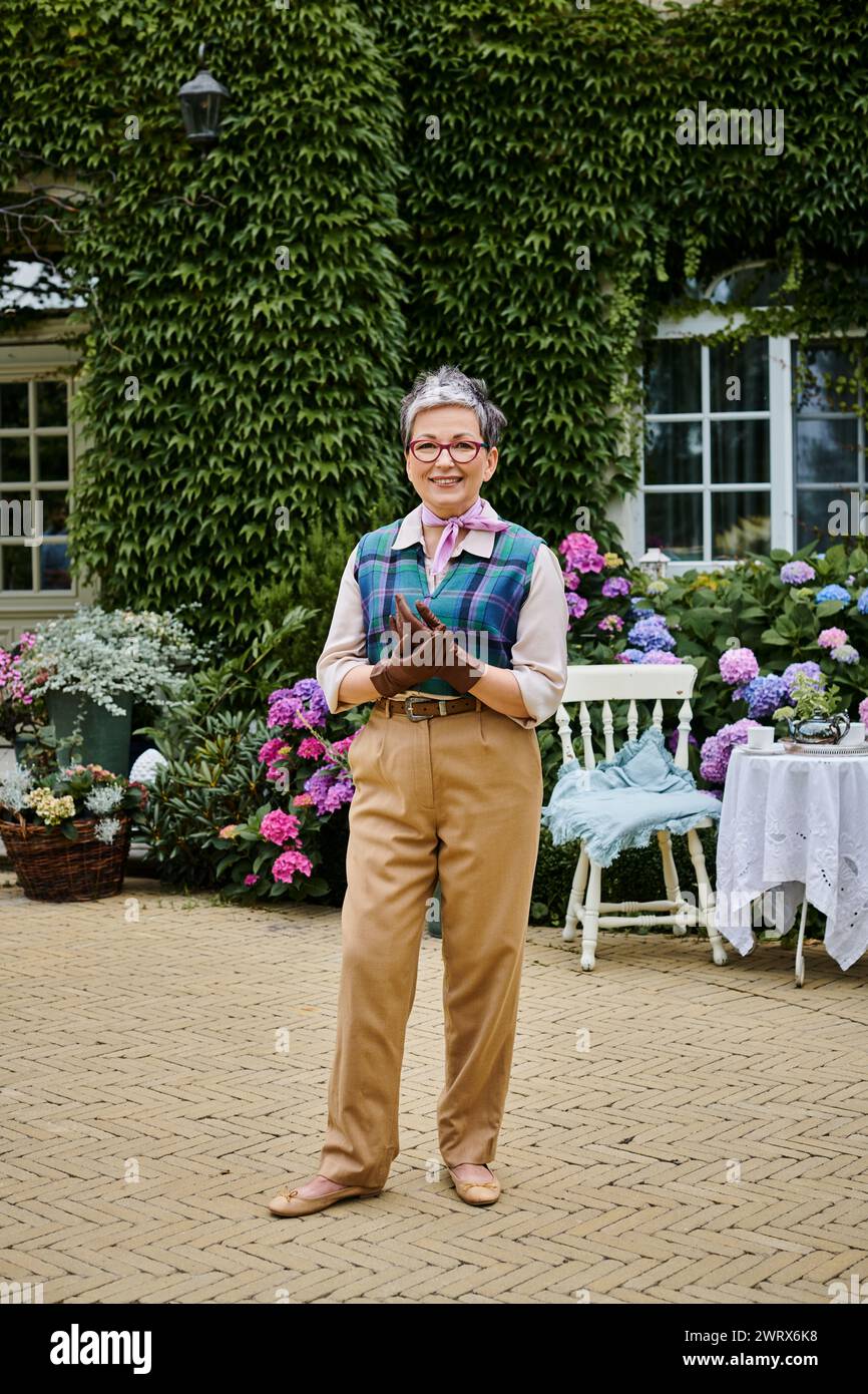 elegant mature jolly woman in chic attire posing near her house in ...