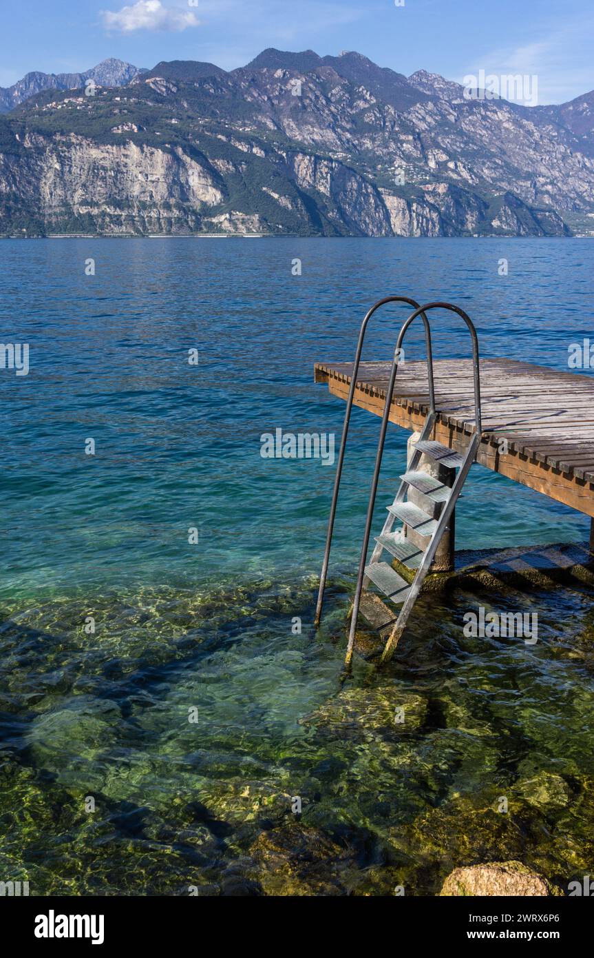a view to a wooden jetty with steps into water of Garga lake and ...