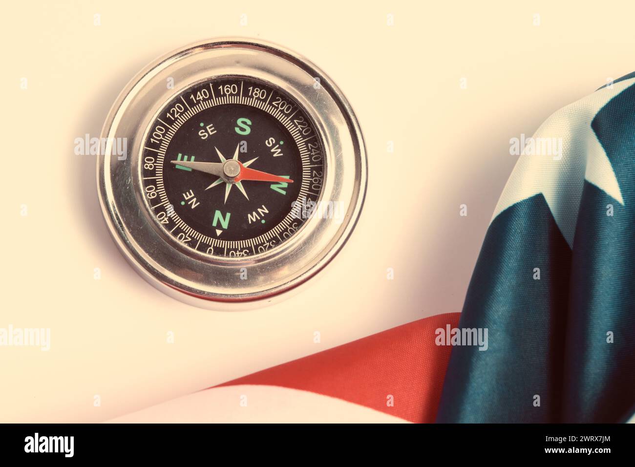 Compass pointing west and star spangled flag United States America ...