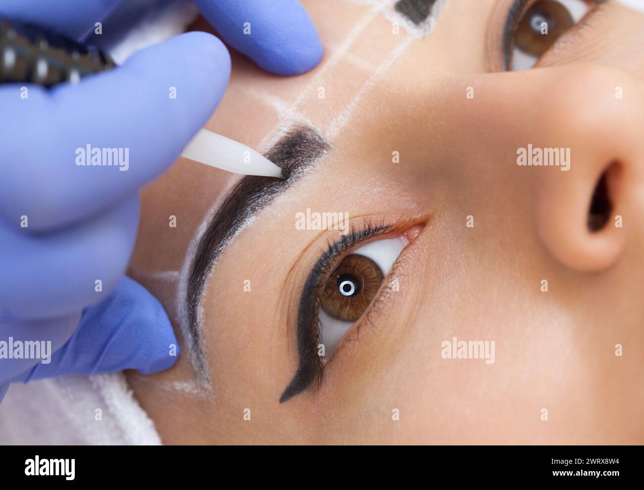 Permanent make-up for eyebrows of beautiful woman with thick brows in ...