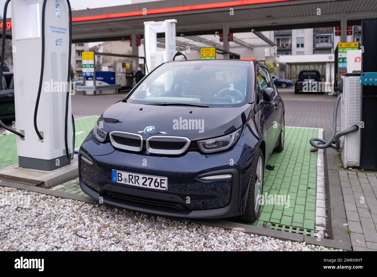 BMW i3 electric car is being charged from an electric charging station ...