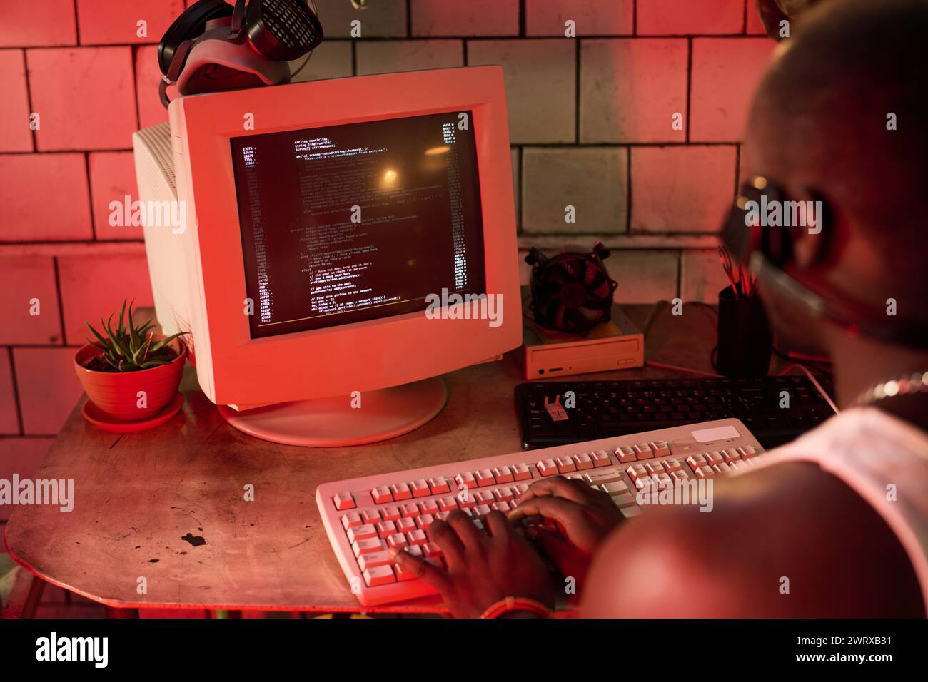 Selective focus over shoulder shot of unrecognizable Black man hacking ...