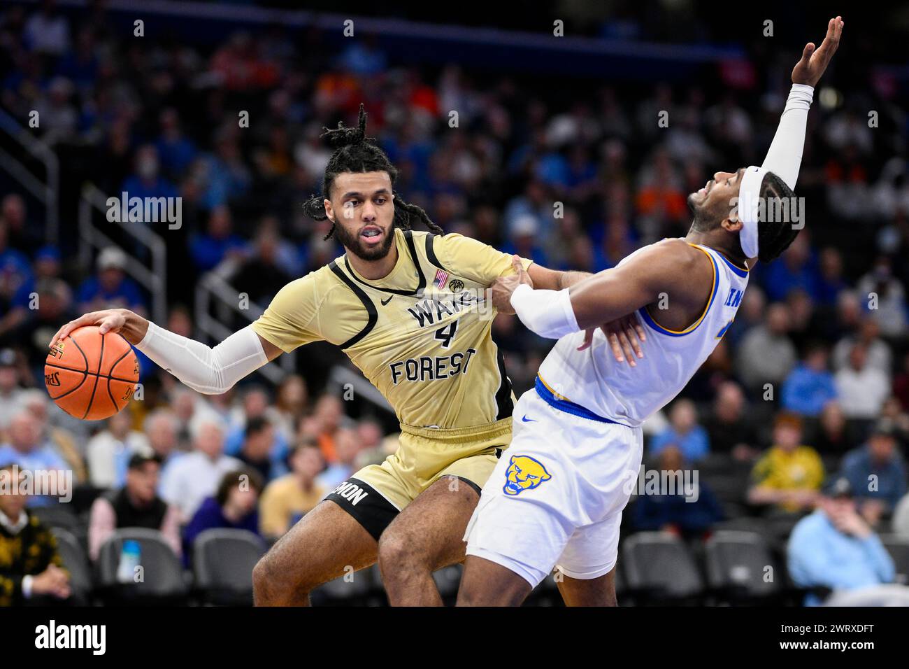 Wake Forest forward Efton Reid III, left, collides with Pittsburgh ...