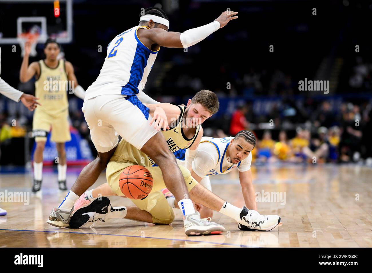 Pittsburgh forward Blake Hinson, left, Wake Forest forward Andrew Carr ...