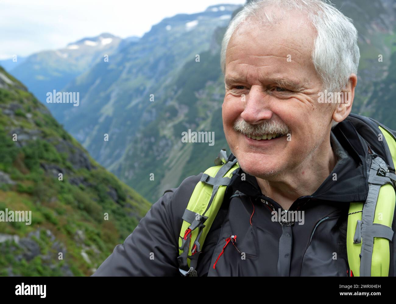 Senior backpacker hiking alone in beautiful landscape. Symbol for ...