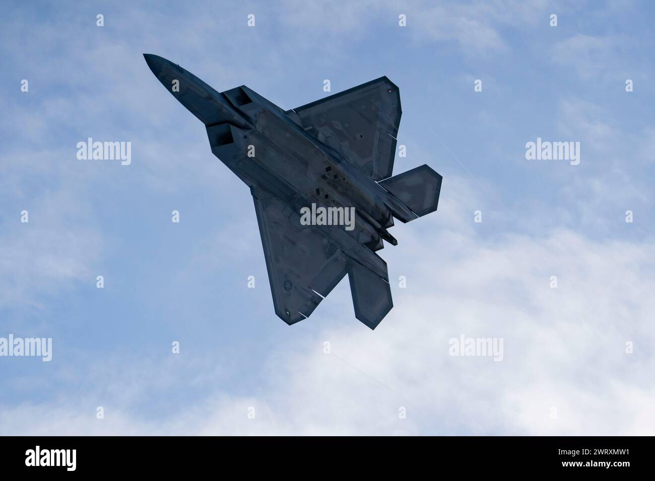 A U.S. Air Force F-22 Raptor assigned to the 3rd Wing takes off above ...