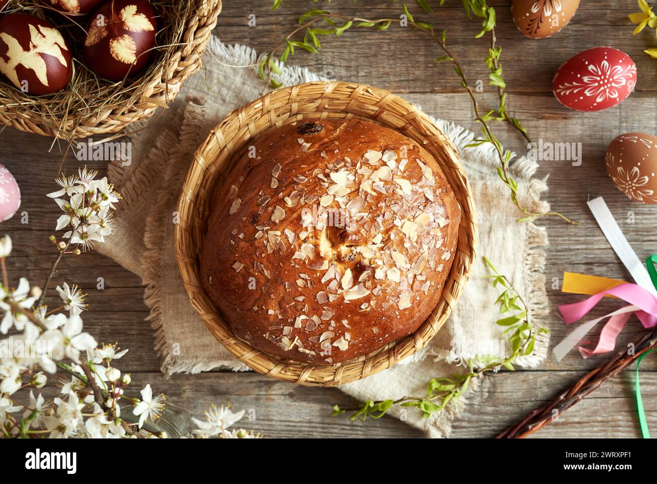 Traditional Czech sweet Easter cake called mazanec, with eggs dyed with ...