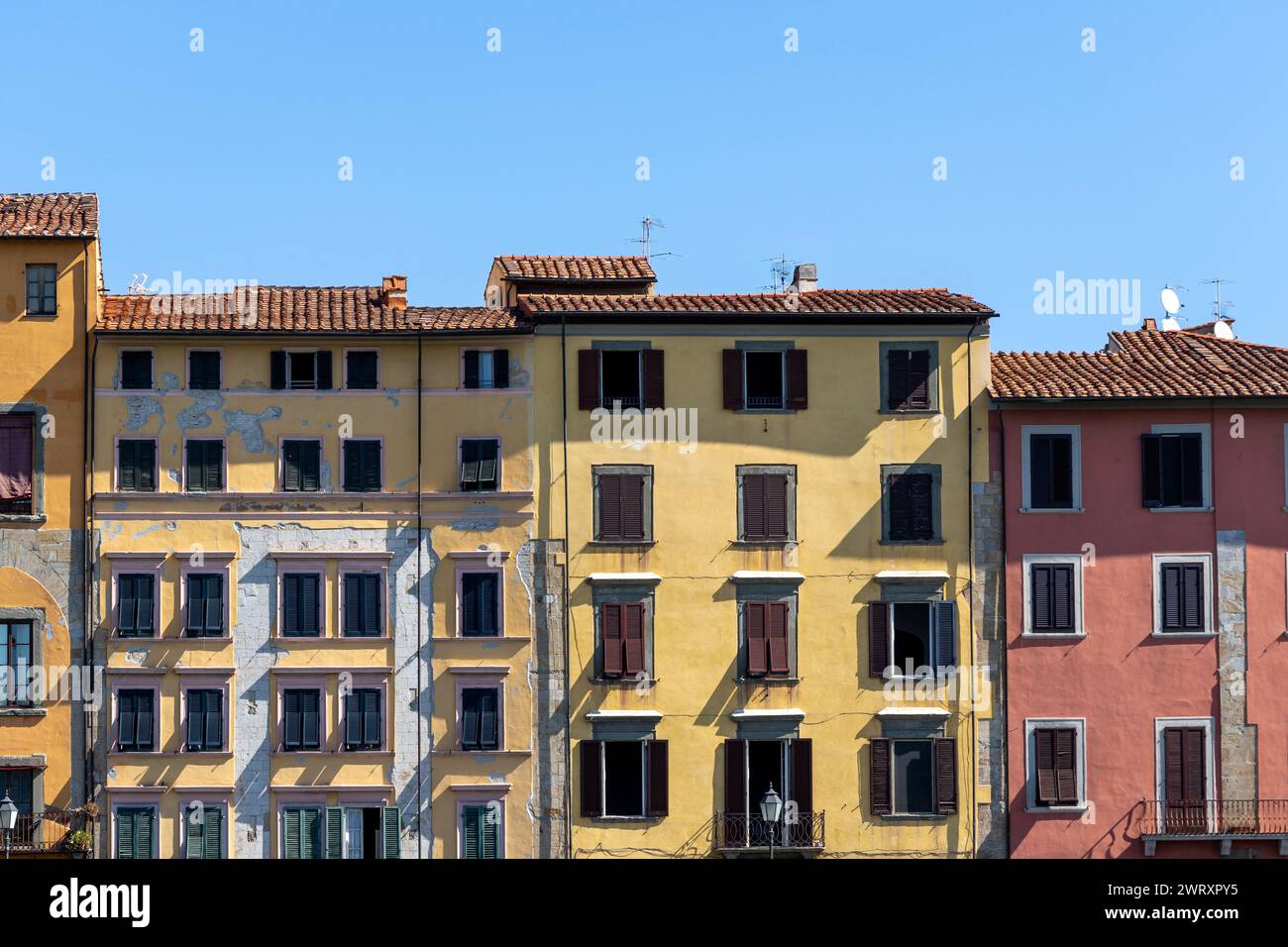 Apartment houses in Pisa, Italy. Derelict condition with plaster coming ...
