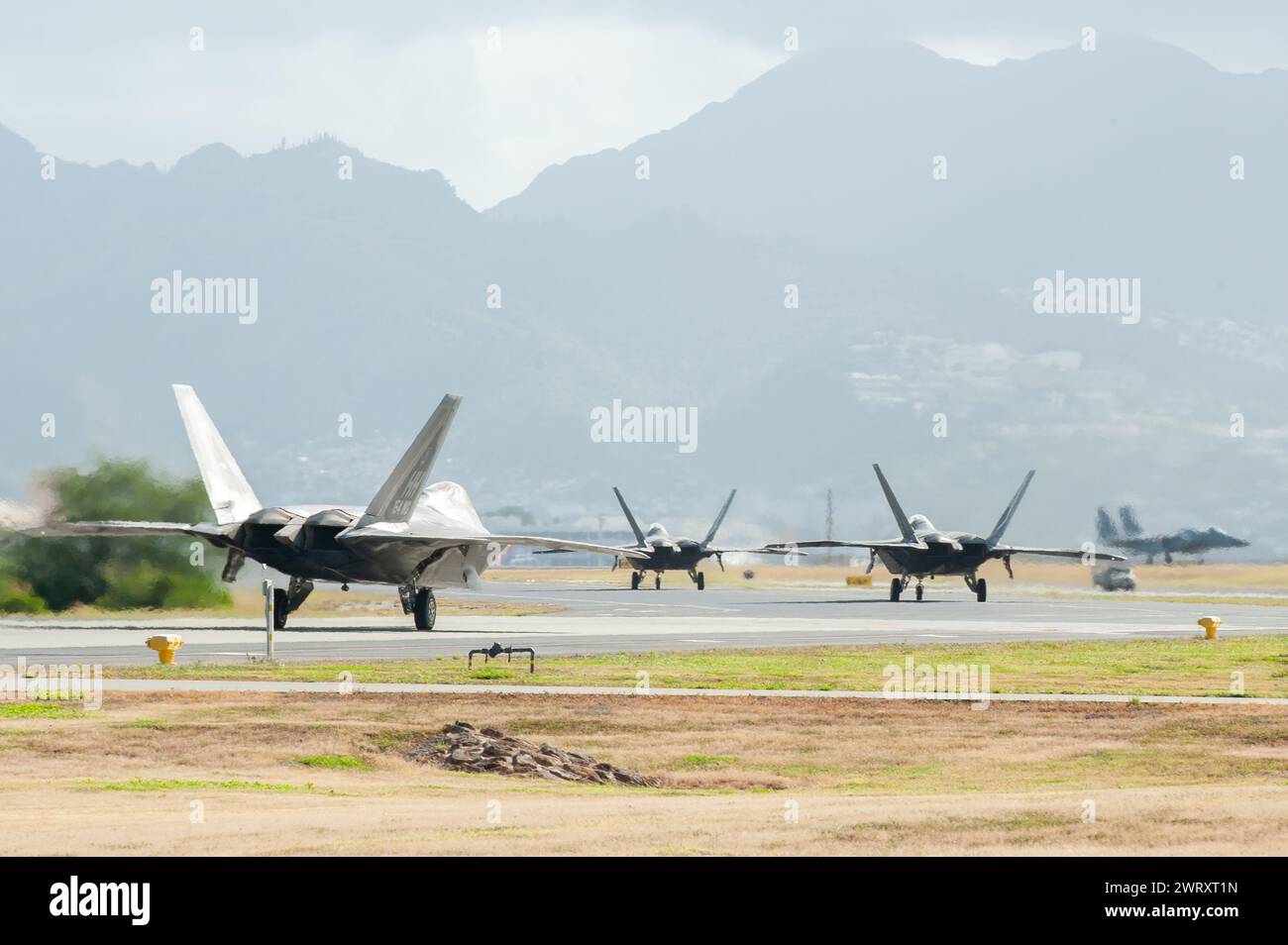 F-22 Raptors, operated by the 199th and 19th Fighter Squadrons, taxi ...