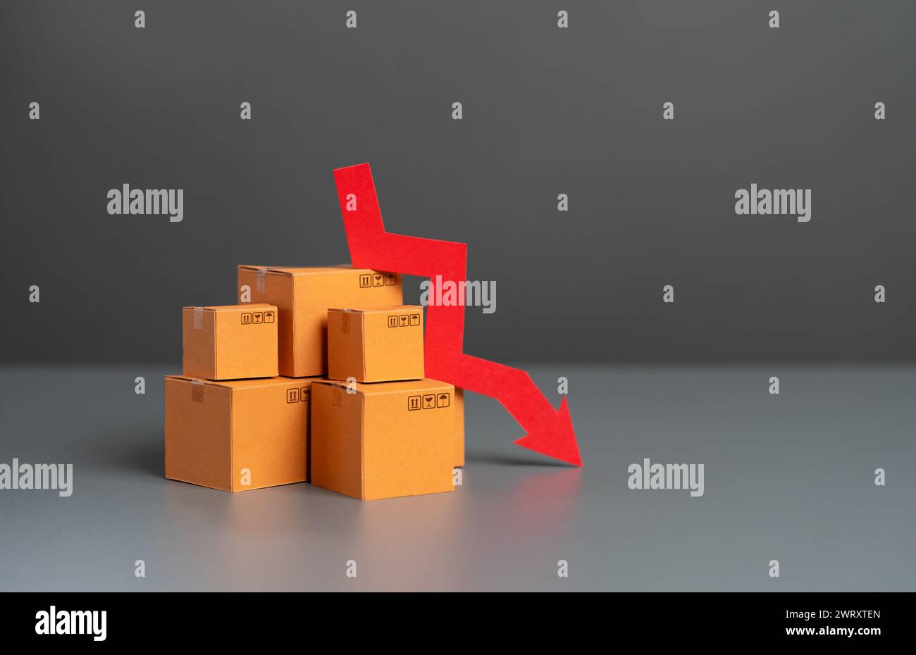 Boxes with goods and down arrow. Falling prices. Reduction in supplies ...