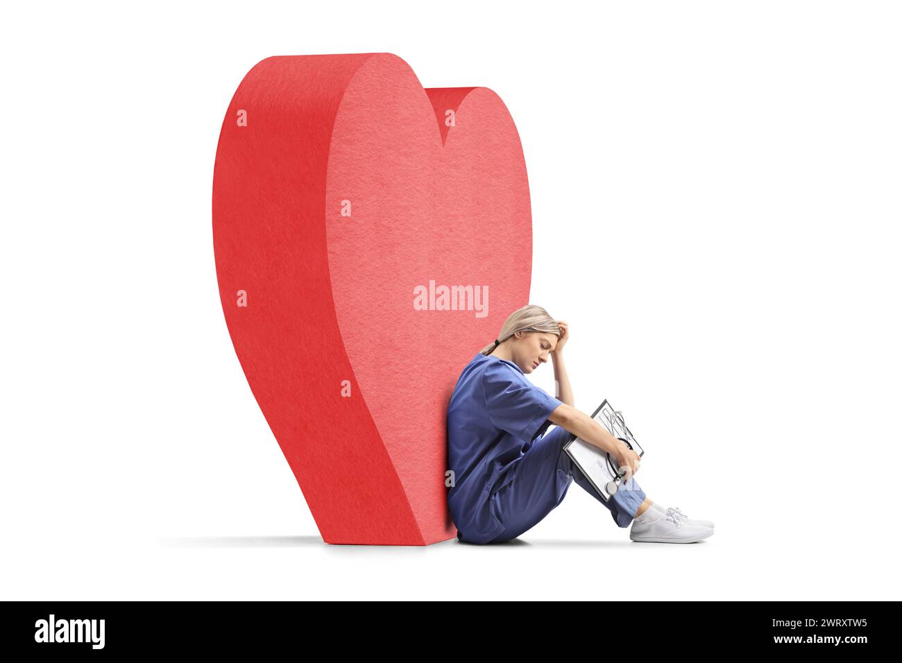 Female doctor sitting on the ground and leaning on a red heart isolated ...