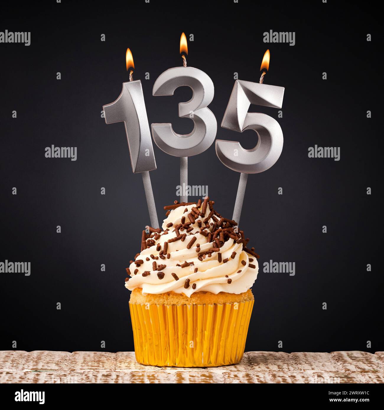 Birthday candle number 135 - Anniversary cupcake on black background ...