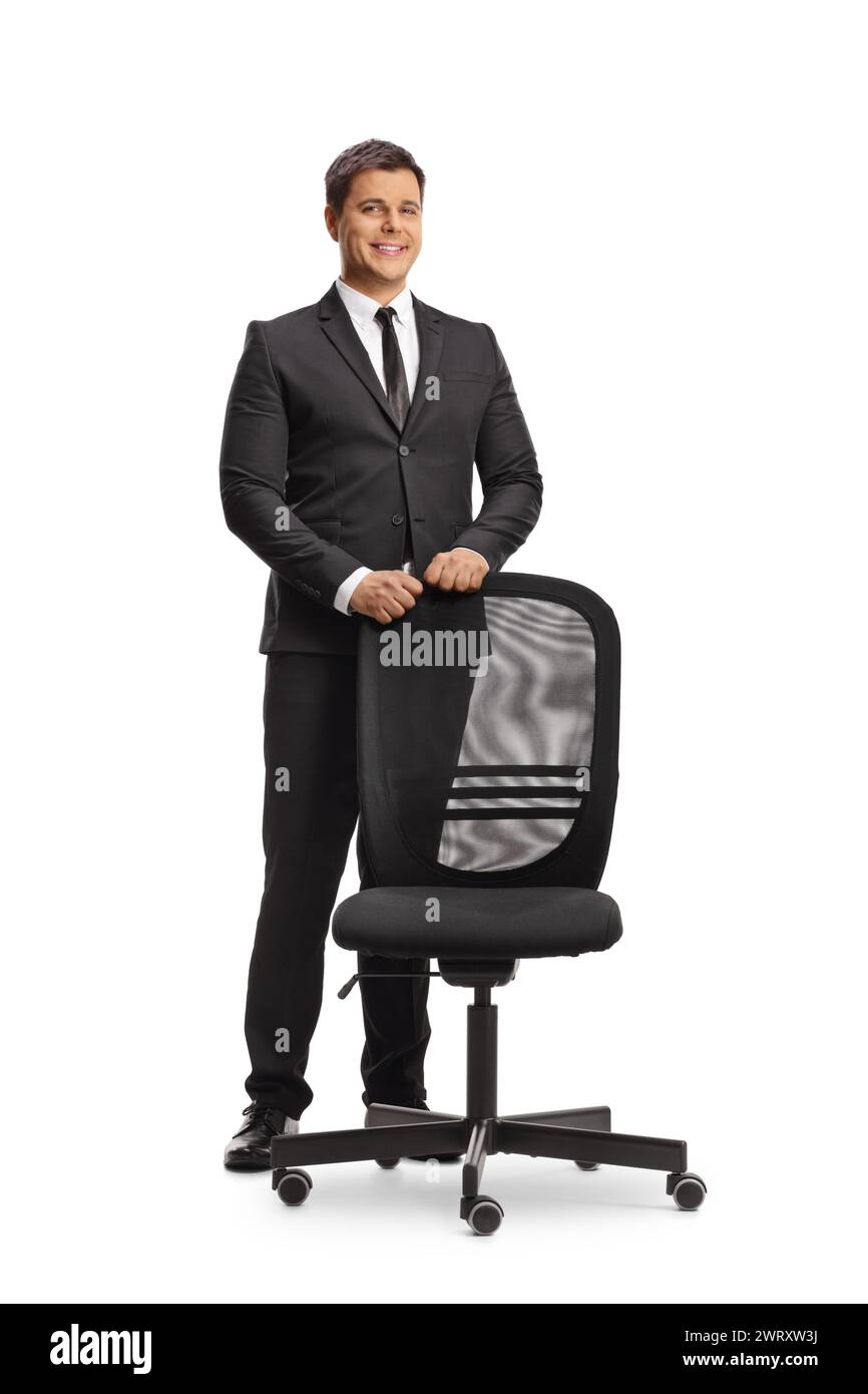 Businessman standing behind an office chair isolated on white ...