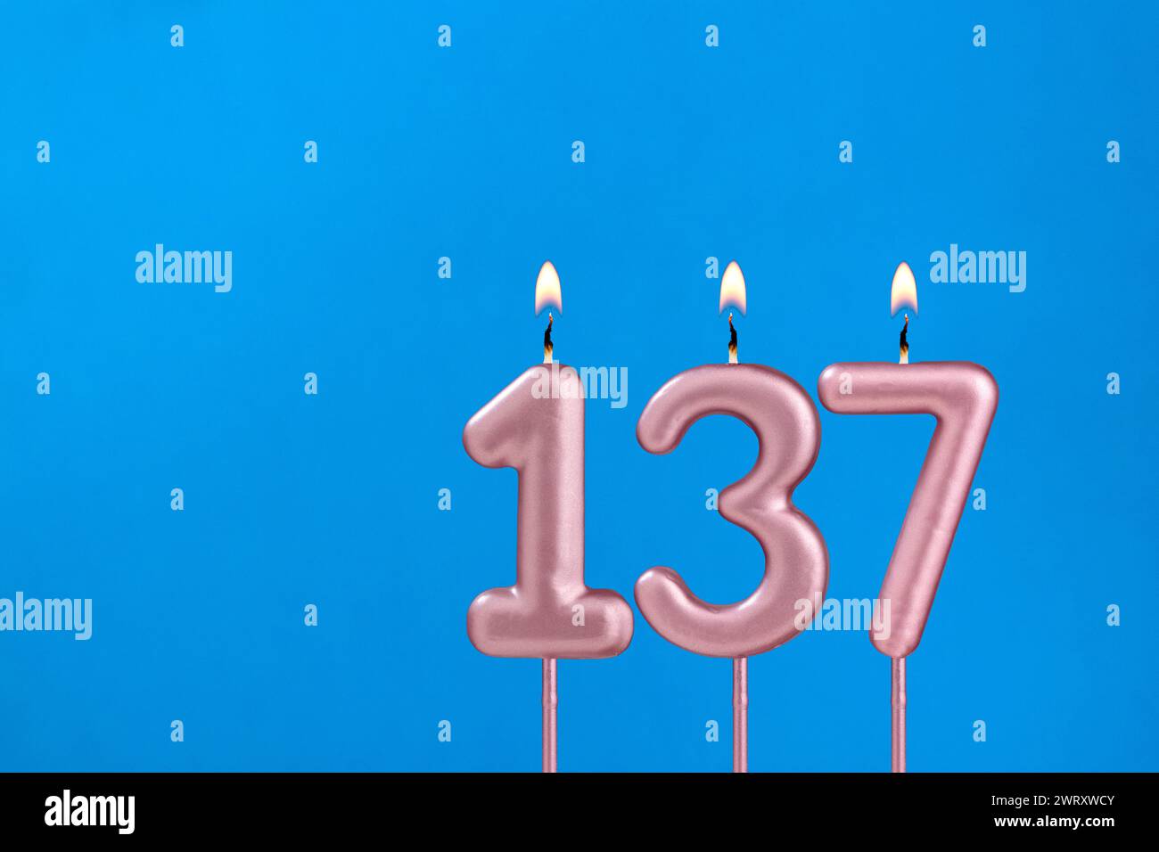 Birthday card with number 137 - Burning anniversary candle on blue ...