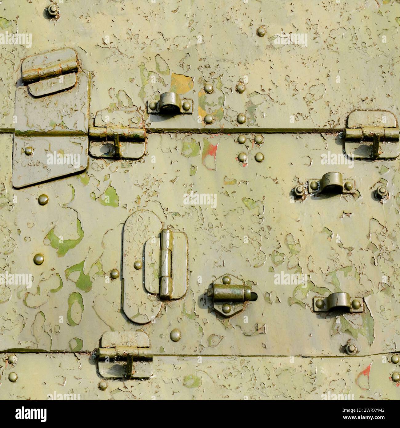 Seamless texture photo of rusty and worn armored green vehicle surface with hinges and rivets ...