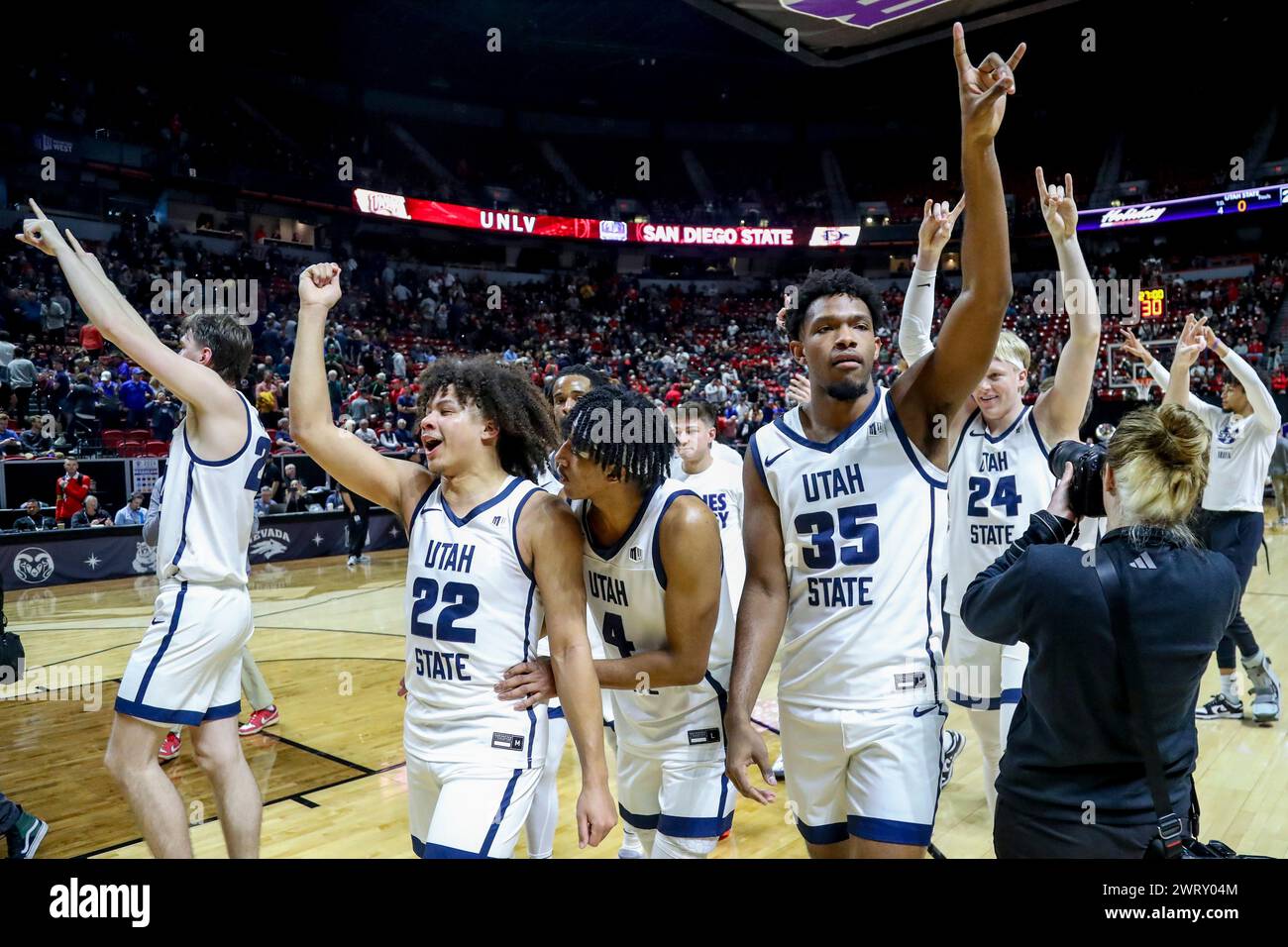 Utah State's Javon Jackson (22), Ian Martinez (4), and Nigel Burris (35 ...