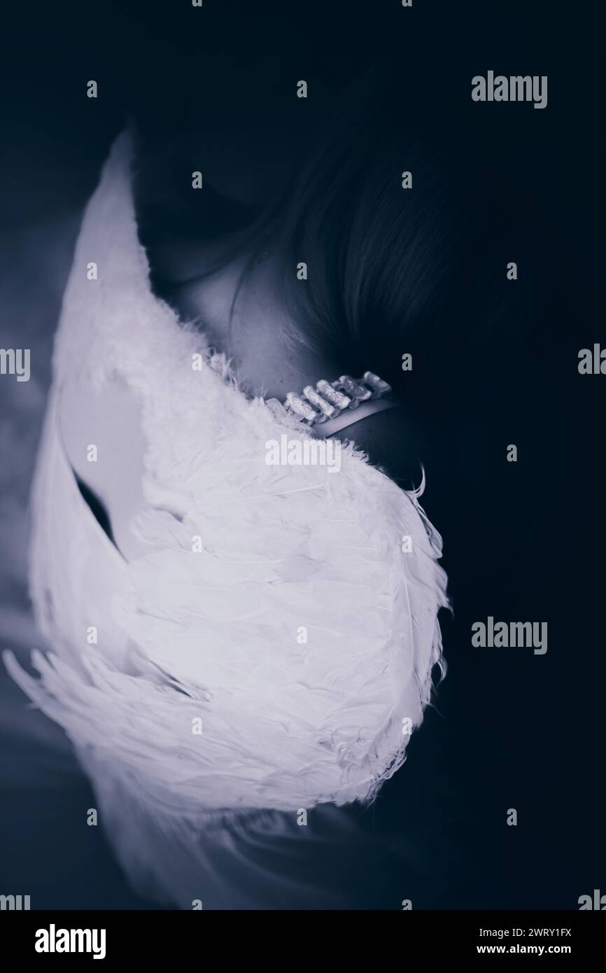 A black-and-white photograph of a beautiful angel from behind, whose ...