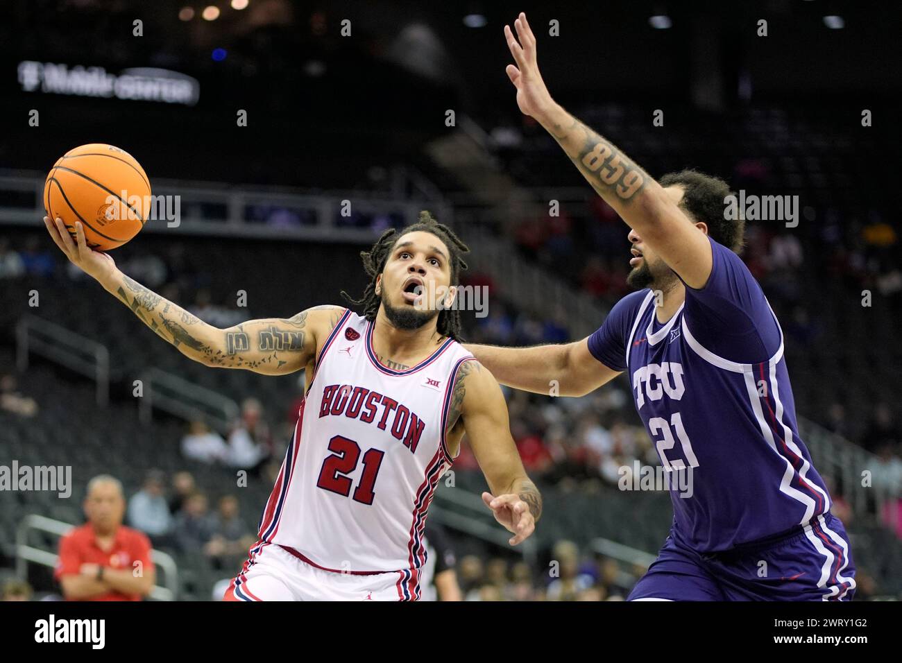 Houston guard Emanuel Sharp, left, goes up for a shot under pressure ...