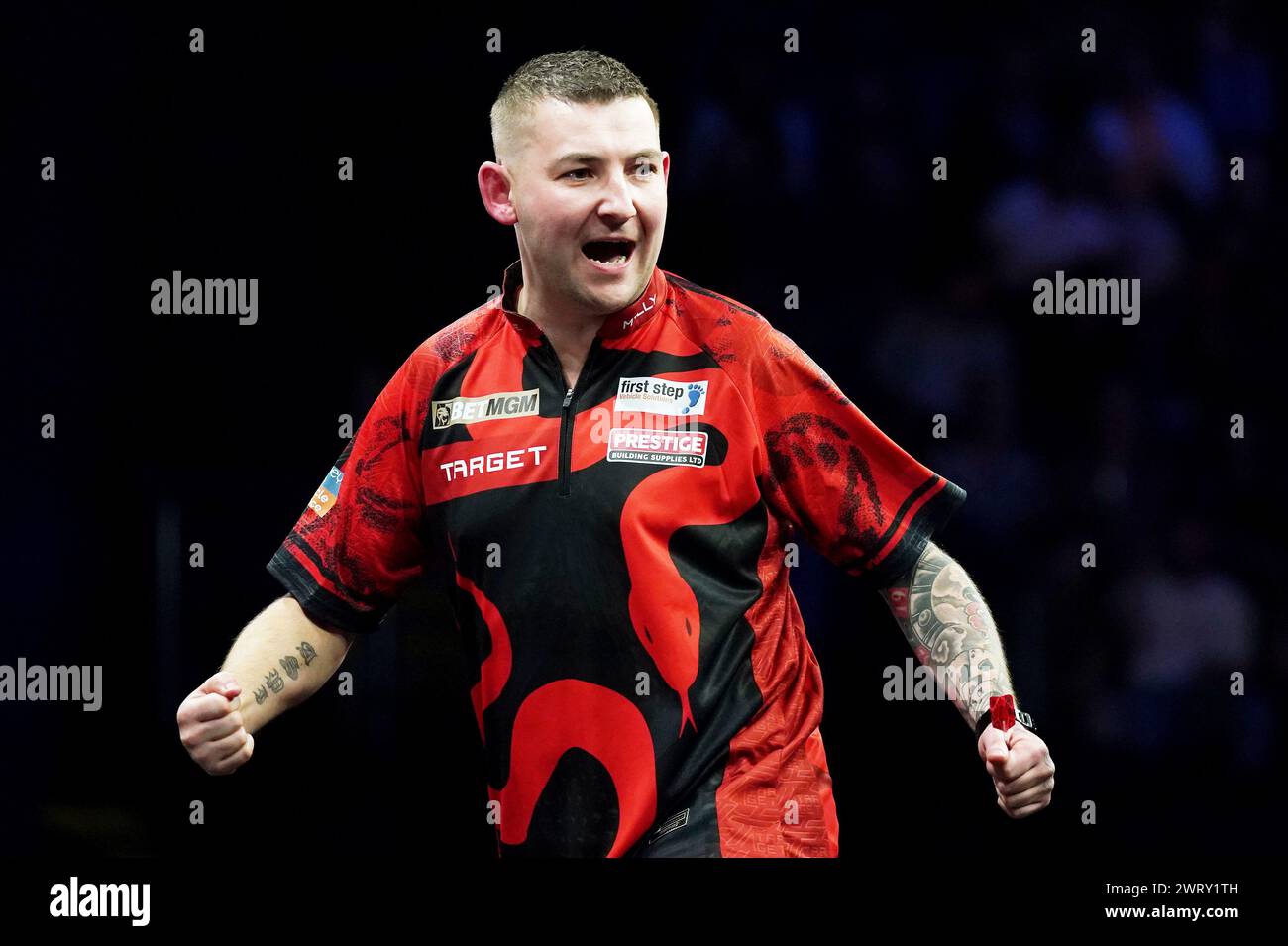 Nathan Aspinall celebrates during their match against Luke Littler (not ...