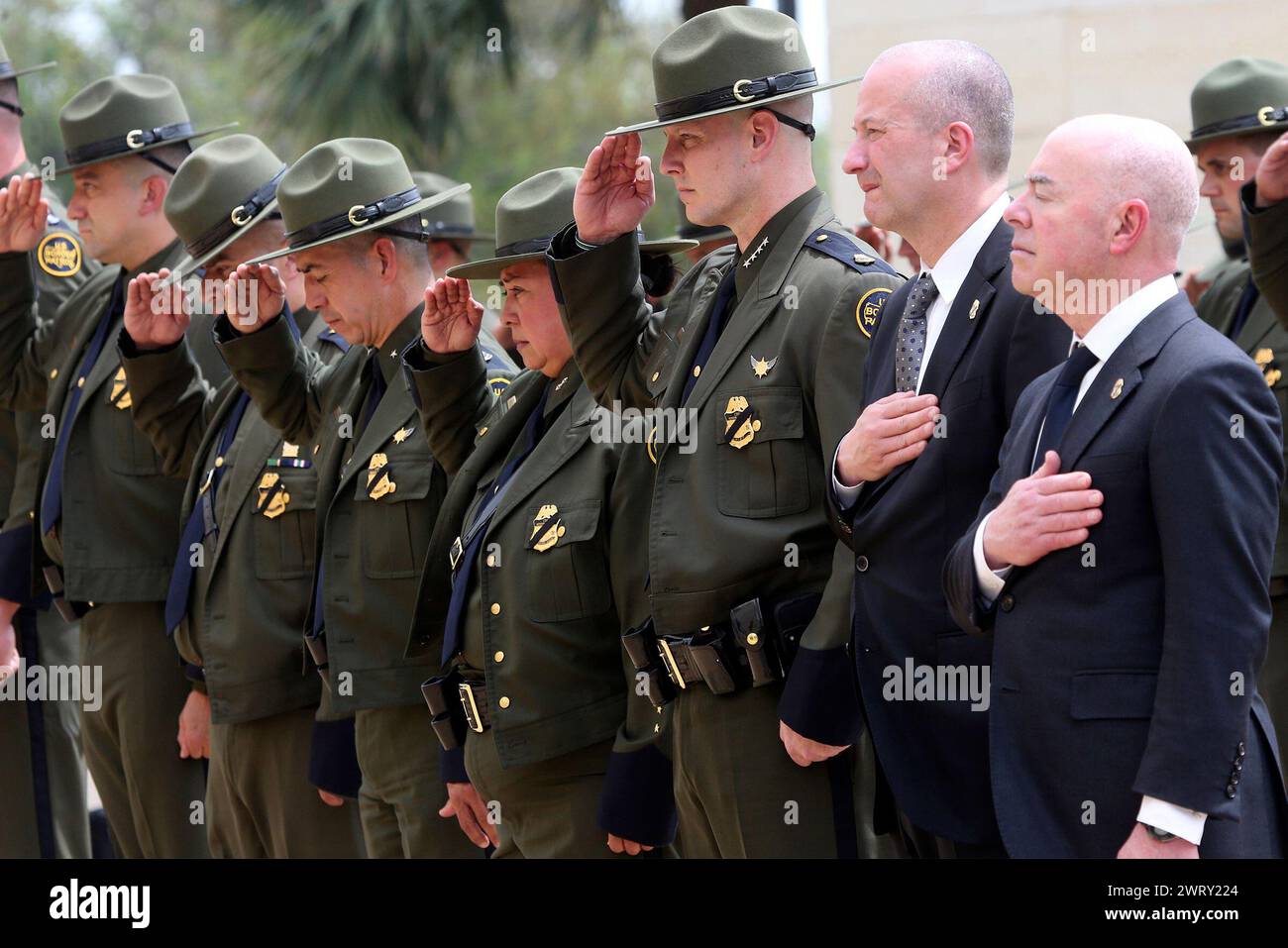 U.S. Border Patrol agents stand at attention alongside Alejandro ...
