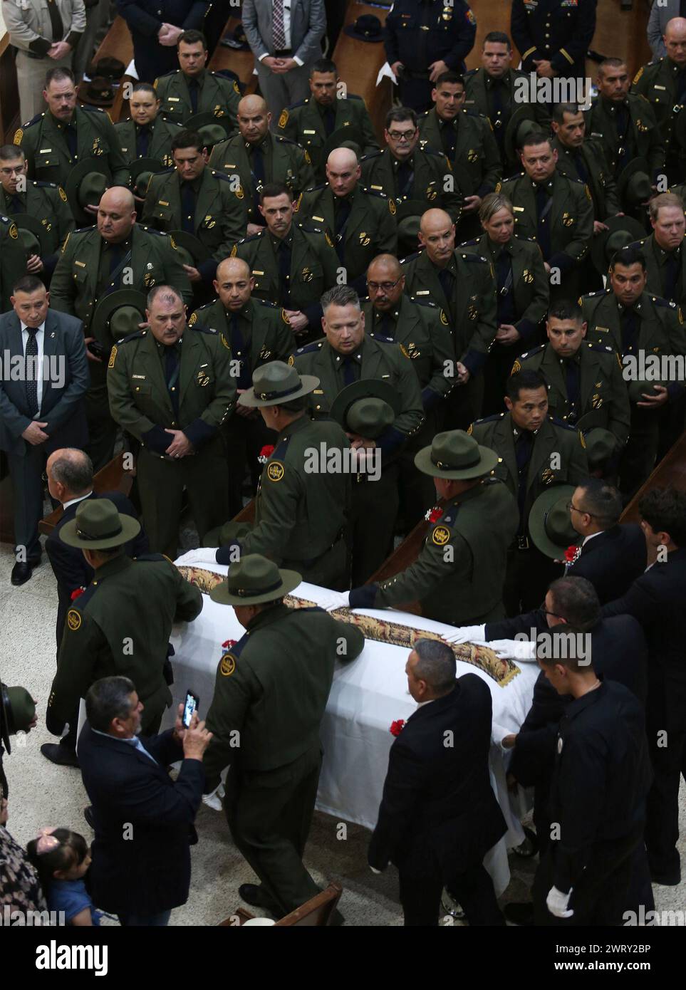 U.S. Border Patrol Agents watch the casket enter during the funeral of ...