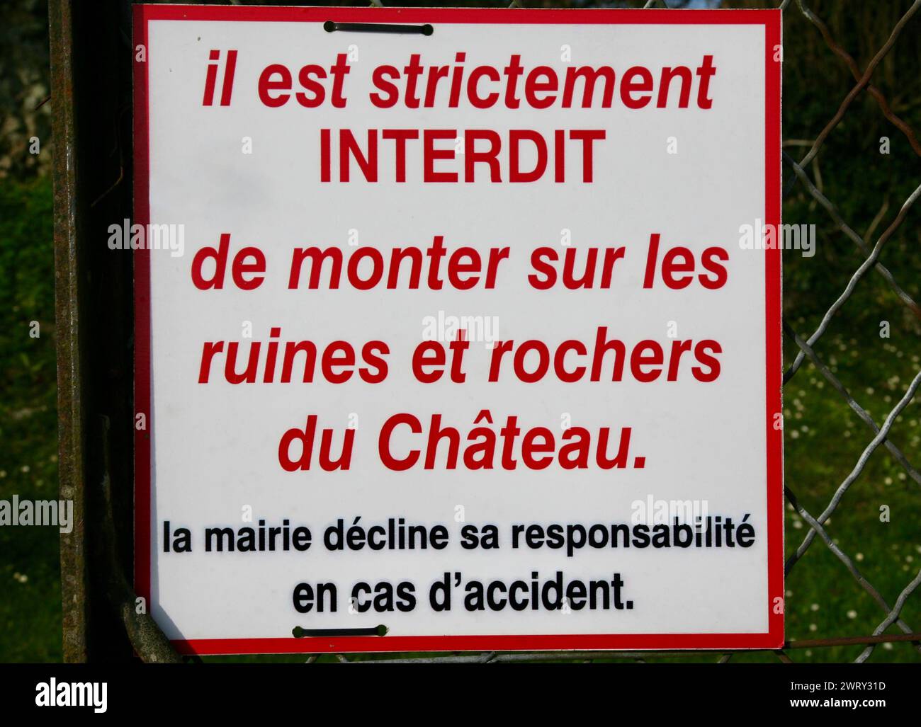 A warning sign at the old medieval chateau, Domfront-en-Poiraie ...