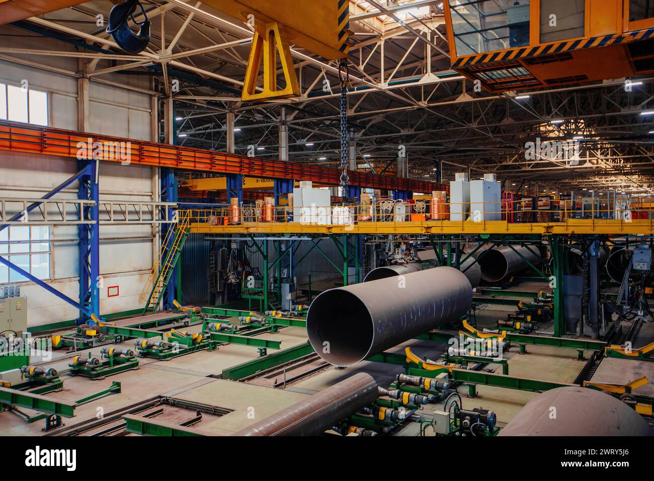 Modern seam pipe factory production line Stock Photo - Alamy