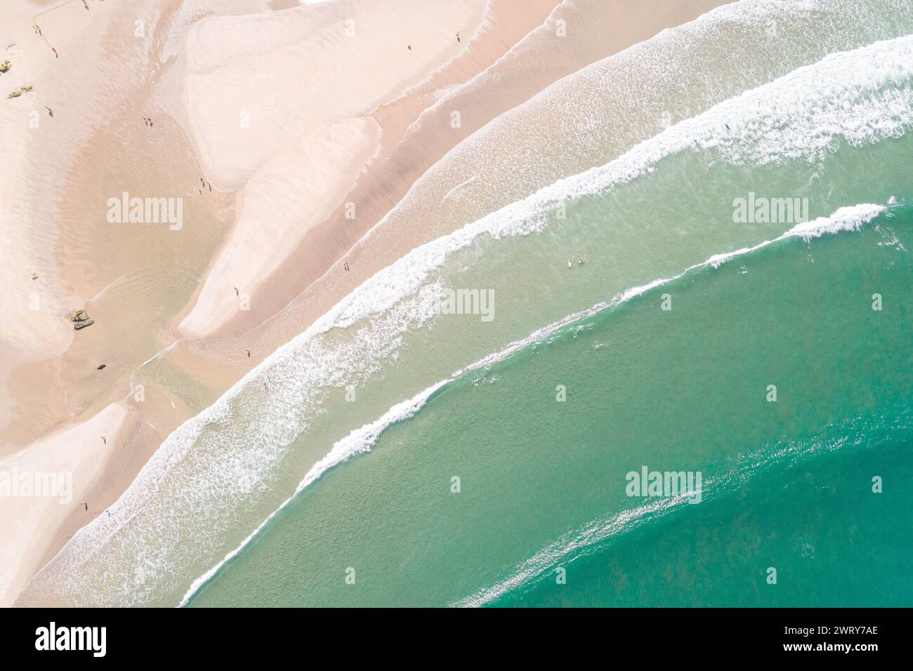 Beach with people enjoying the summer as seen from a drone, zenithal ...