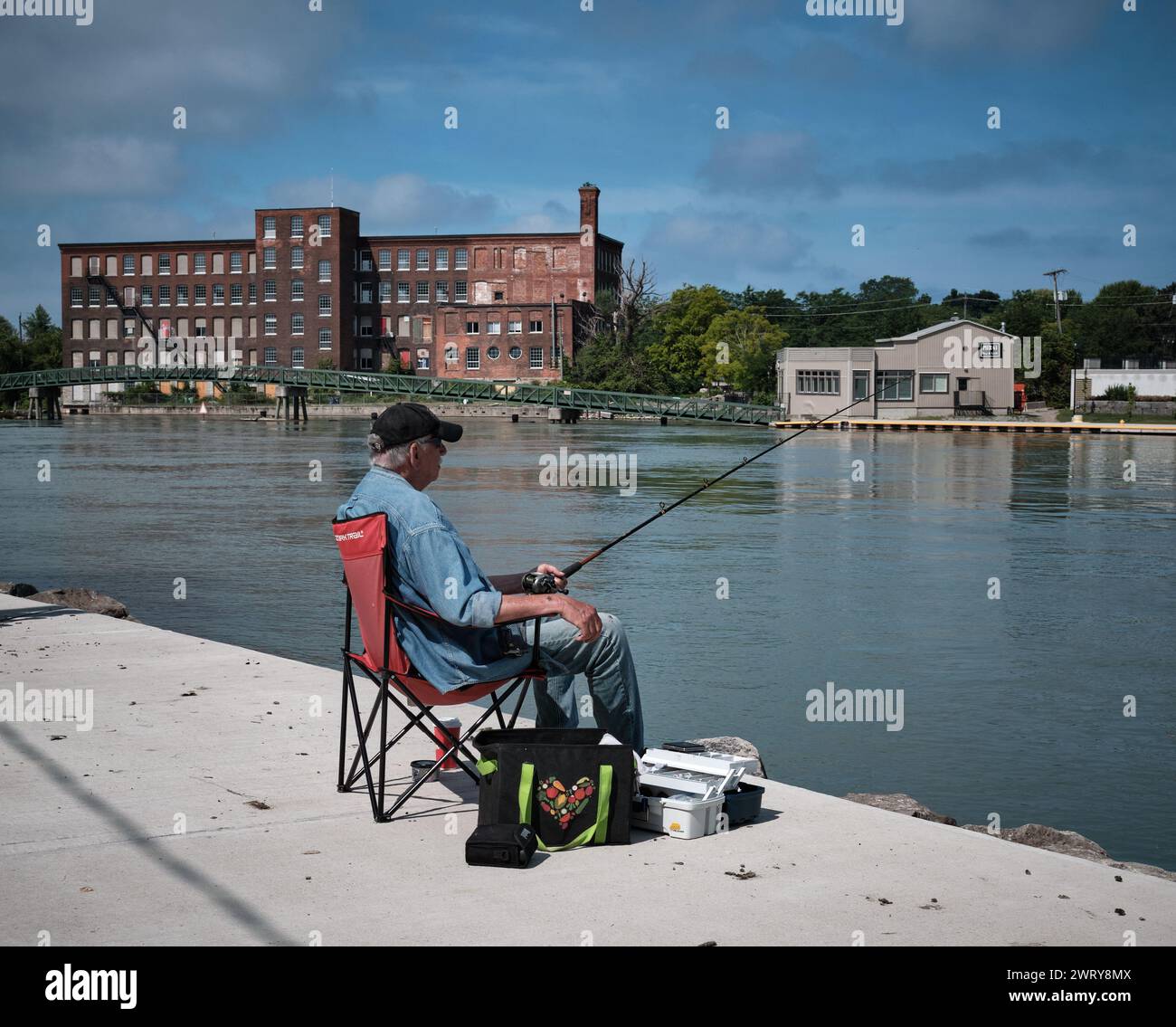 Senior male enjoying an afternoon of fishing off the Port Dalhousie ...