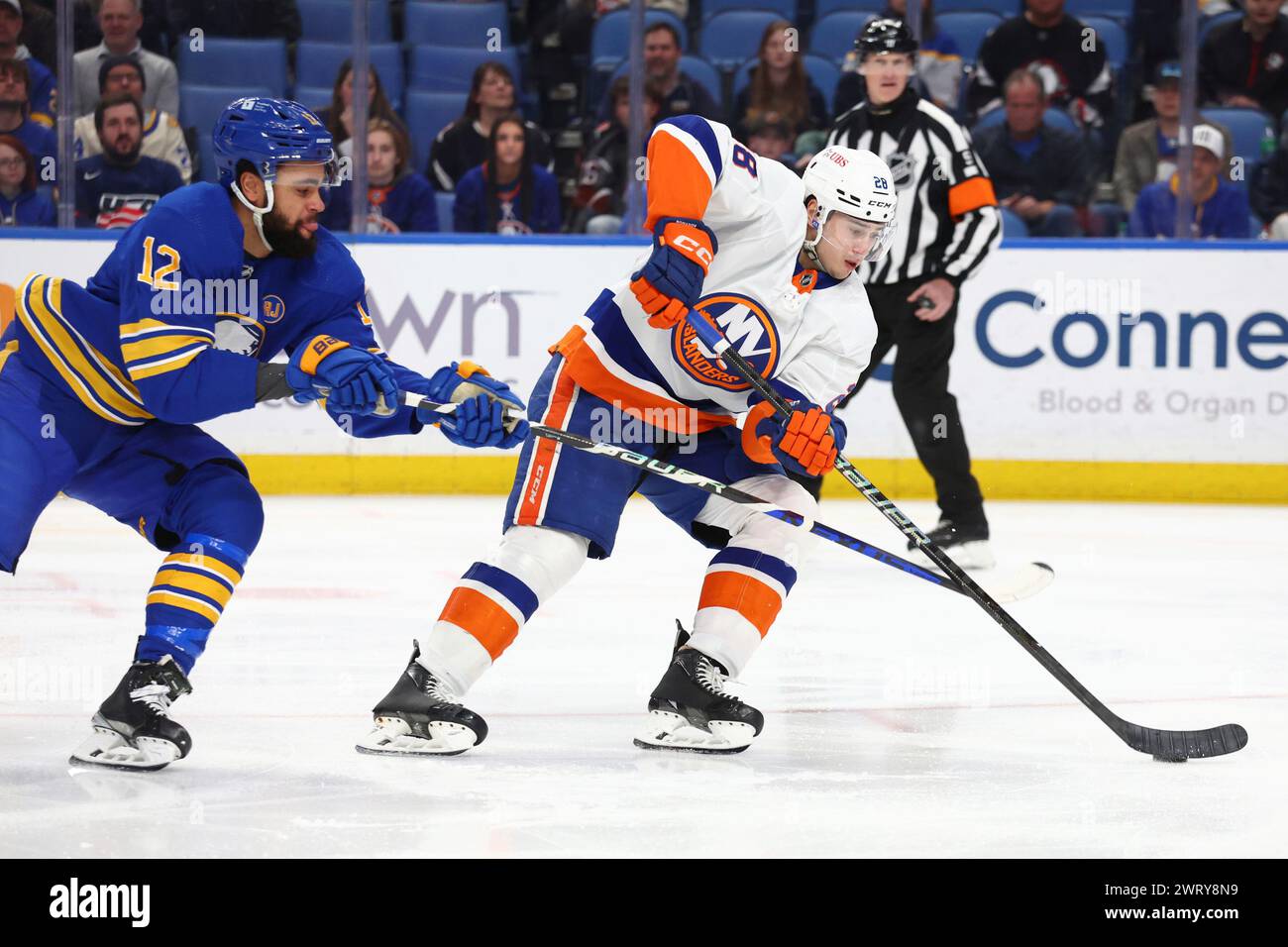 New York Islanders defenseman Alexander Romanov (28) is stick-checked ...