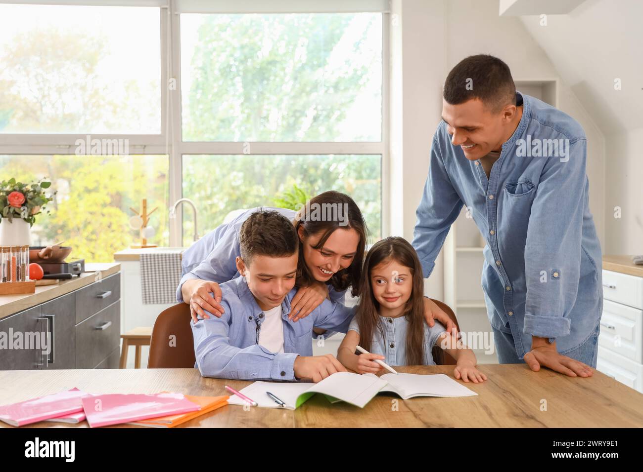 Little children with their parents doing homework in kitchen Stock ...