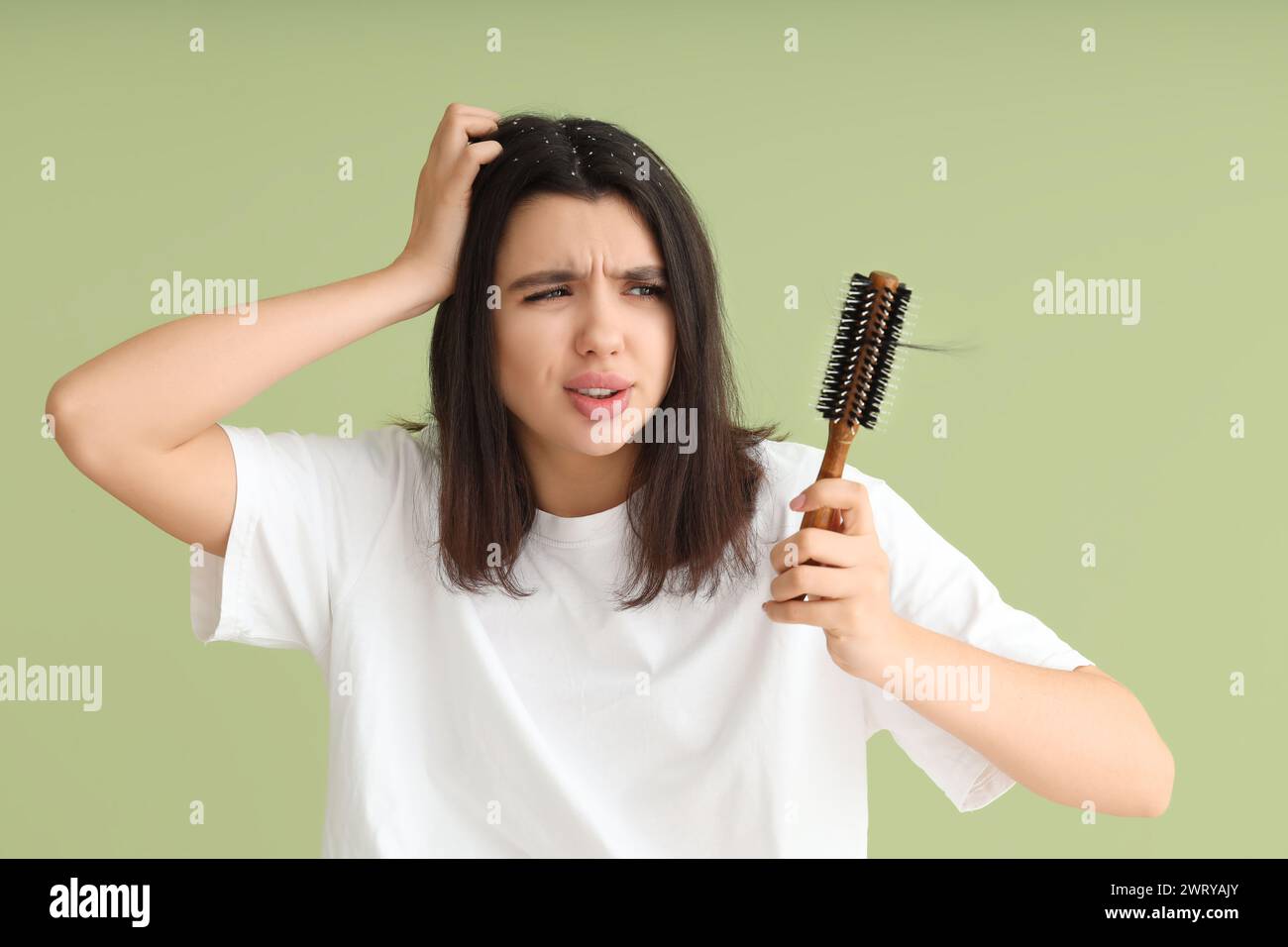 Stressed young woman with hair loss problem on green background Stock ...