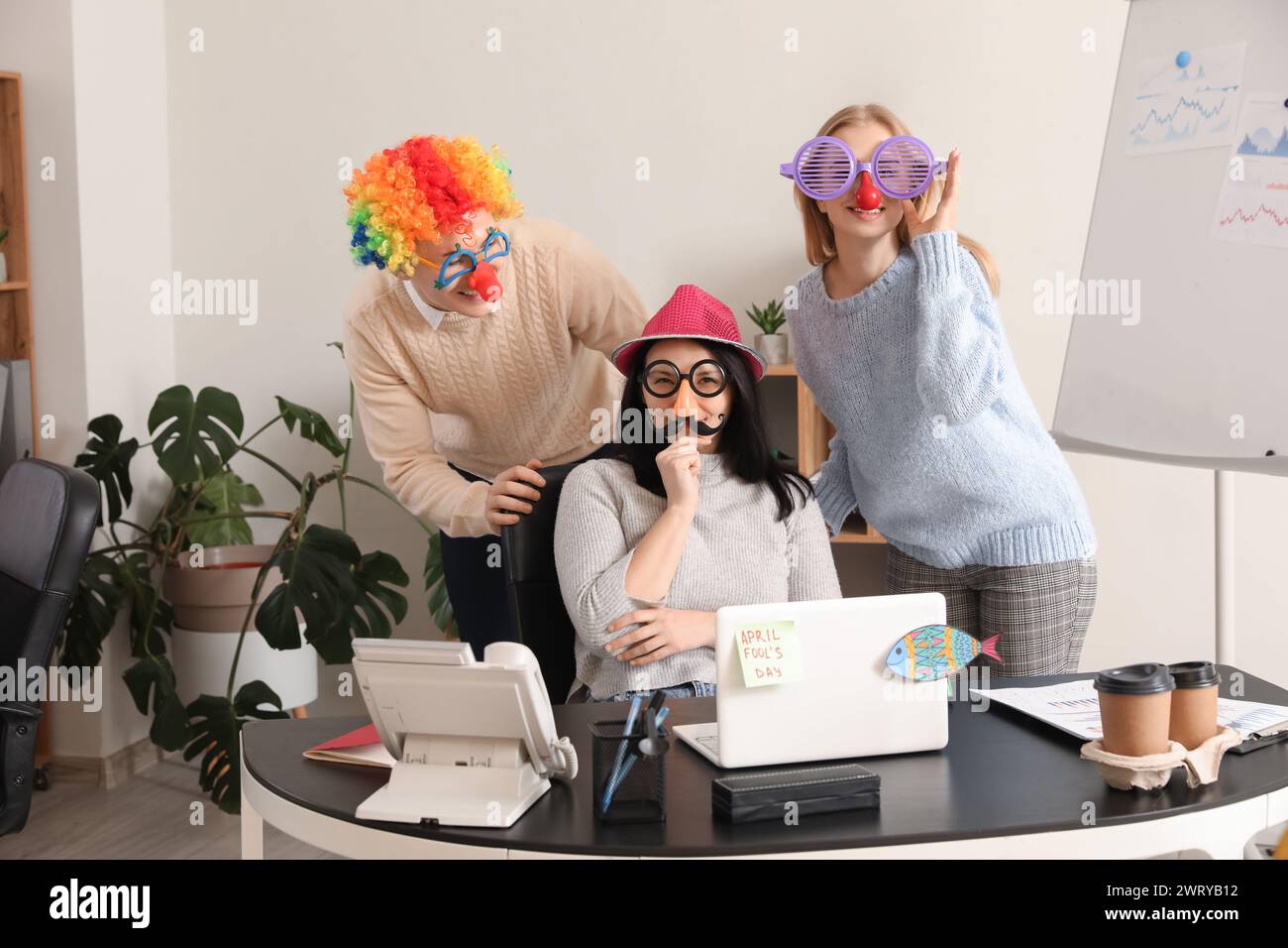 Business people with funny disguise in office. April Fools' Day ...