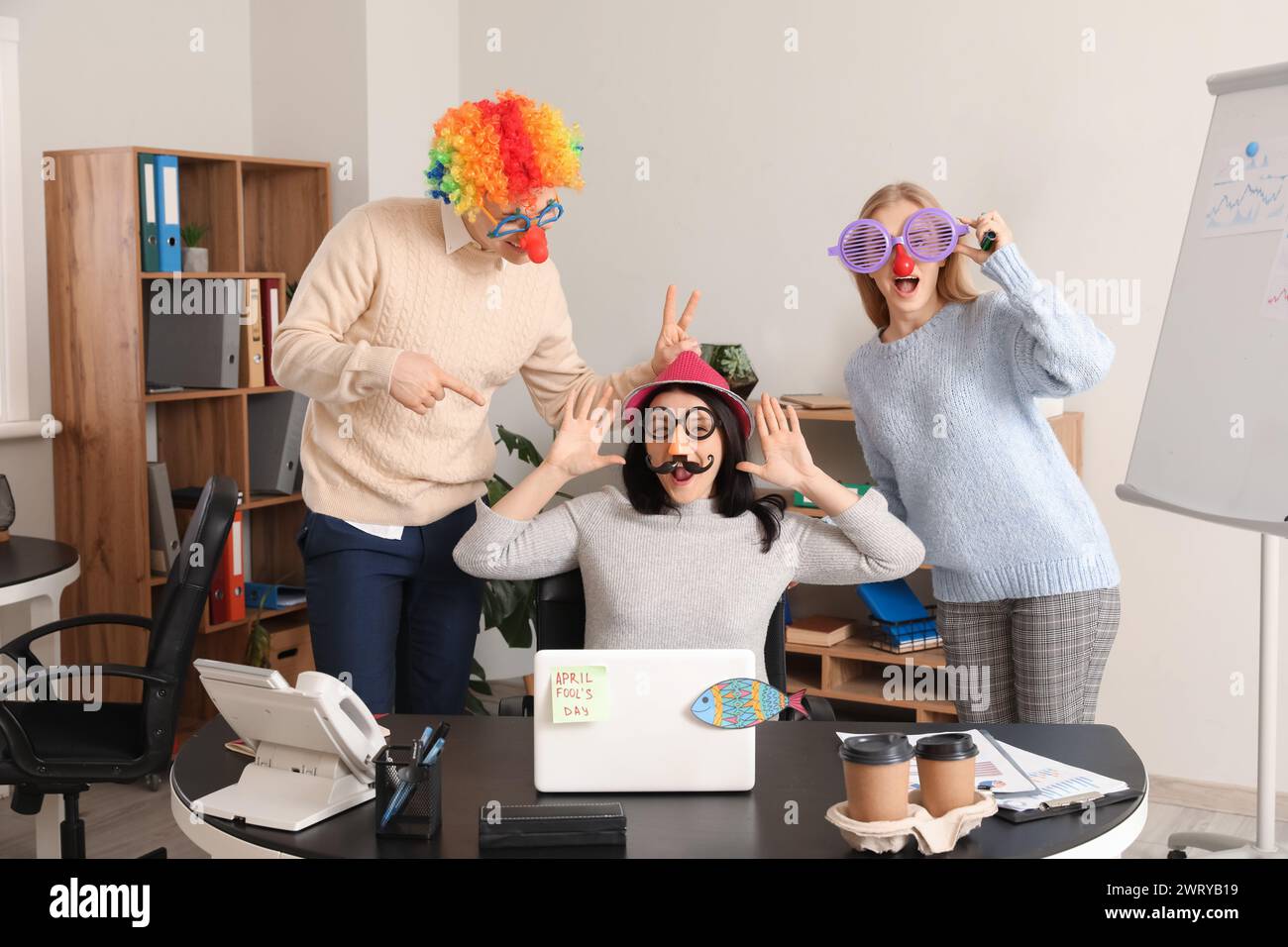 Business people with funny disguise in office. April Fools' Day ...