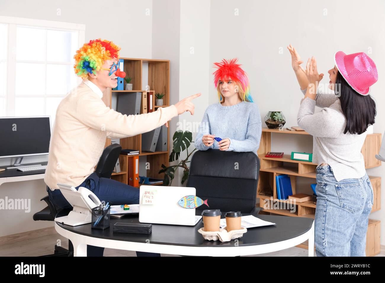 Business people with funny disguise in office. April Fools' Day ...