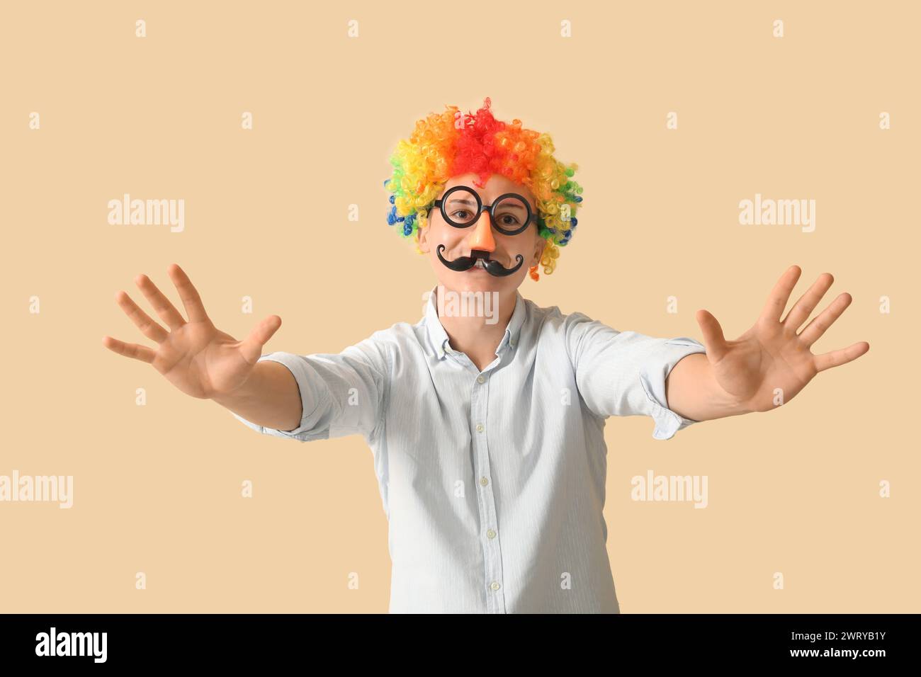 Business man in funny disguise on beige background. April Fools' Day ...