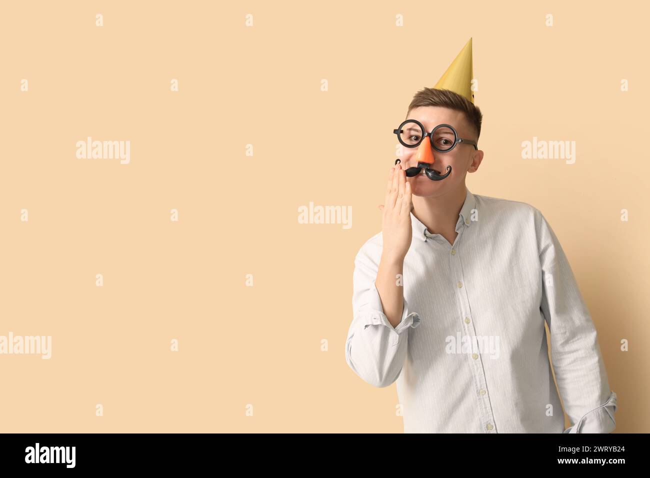 Business man in funny disguise on beige background. April Fools' Day ...