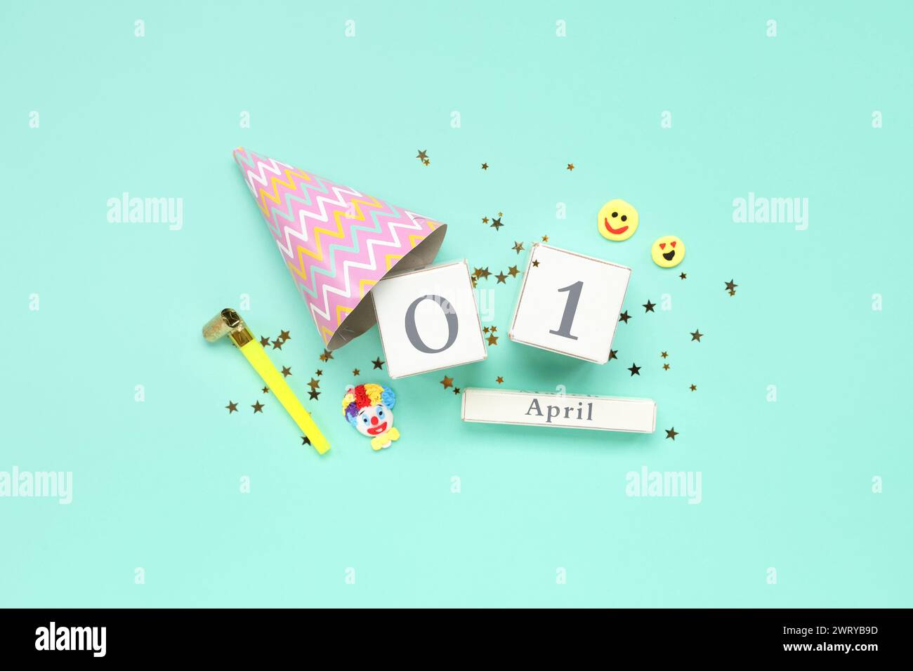 Calendar with party decor on turquoise background. April Fools Day ...