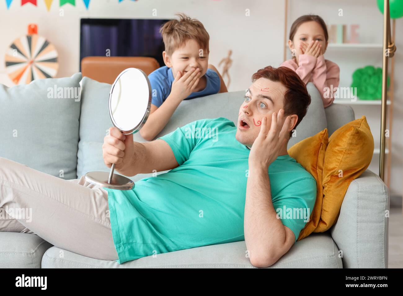 Little kids laughing at their shocked father with paintings on his face ...