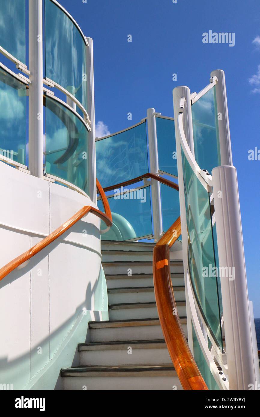 Deck staircase on a cruise ship, with blue sky and bright sunshine ...