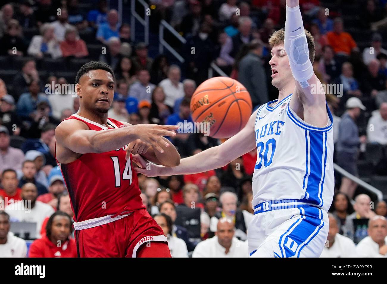 North Carolina State guard Casey Morsell (14) passing the ball past ...
