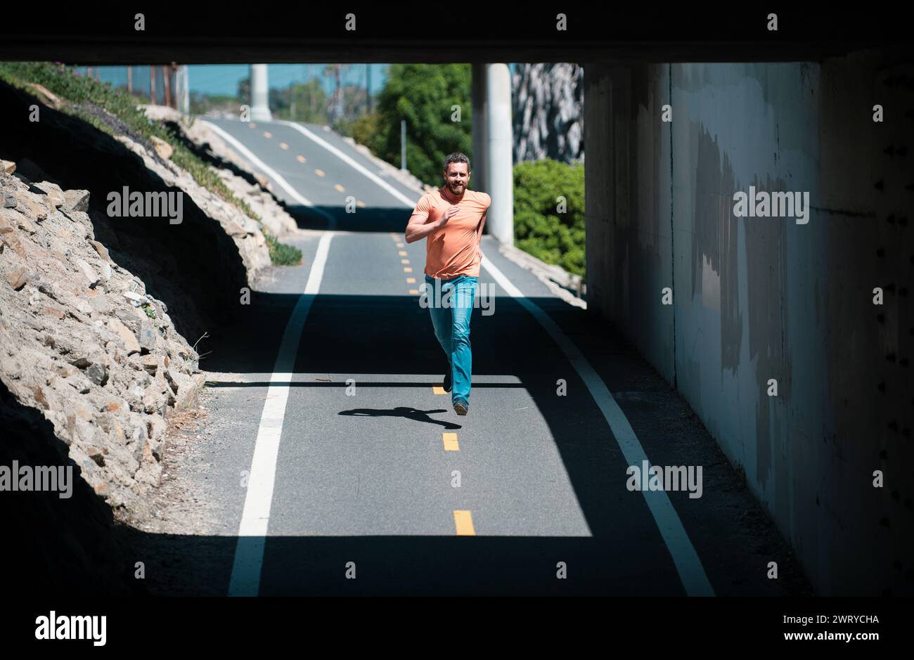 Full length of healthy man running and sprinting outdoors. Young ...