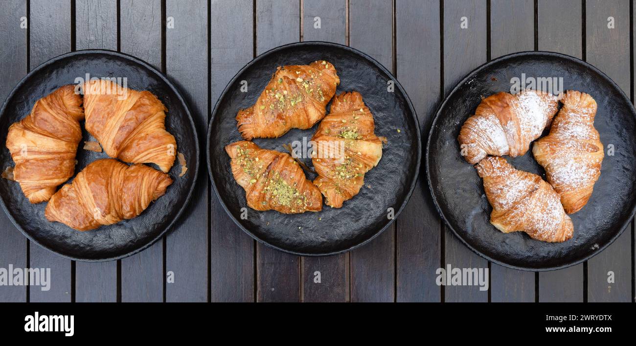 Three different kind of plates of pastries. The top plate has a round ...