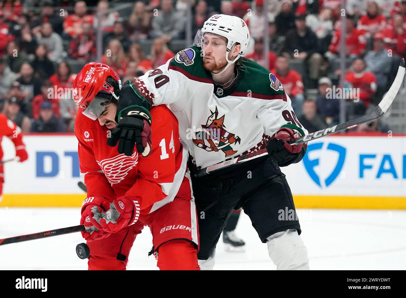Arizona Coyotes defenseman J.J. Moser (90) checks Detroit Red Wings ...