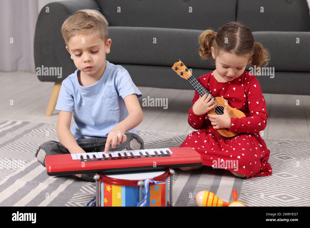 Little children playing toy musical instruments at home Stock Photo - Alamy