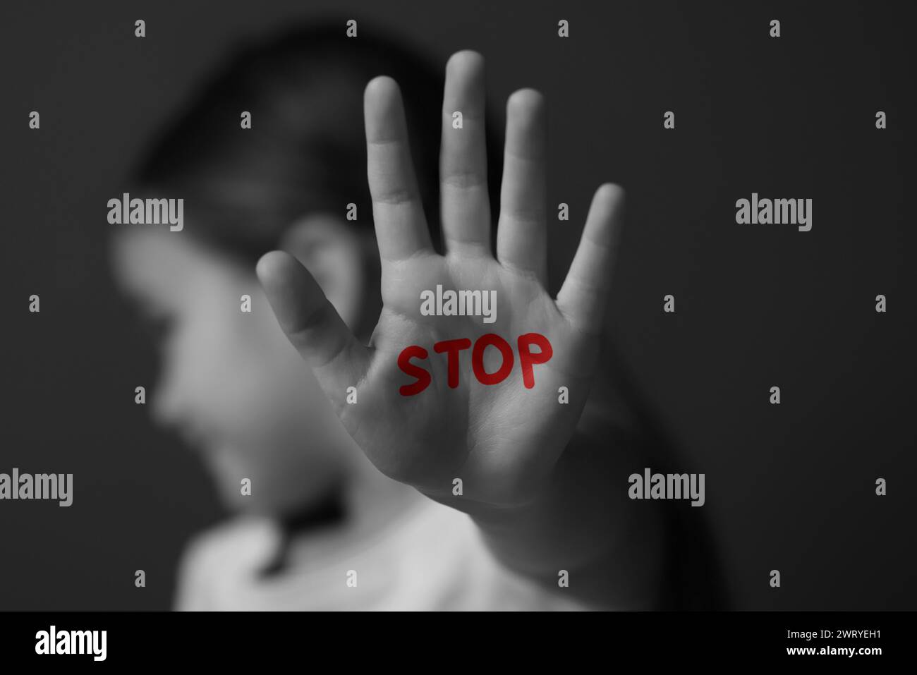No child abuse. Girl showing hand with written Stop on palm, selective ...