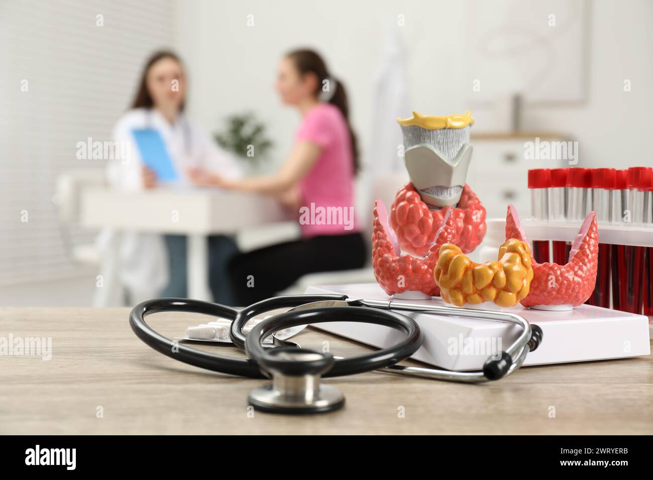 Endocrinologist examining patient at clinic, focus on stethoscope and ...